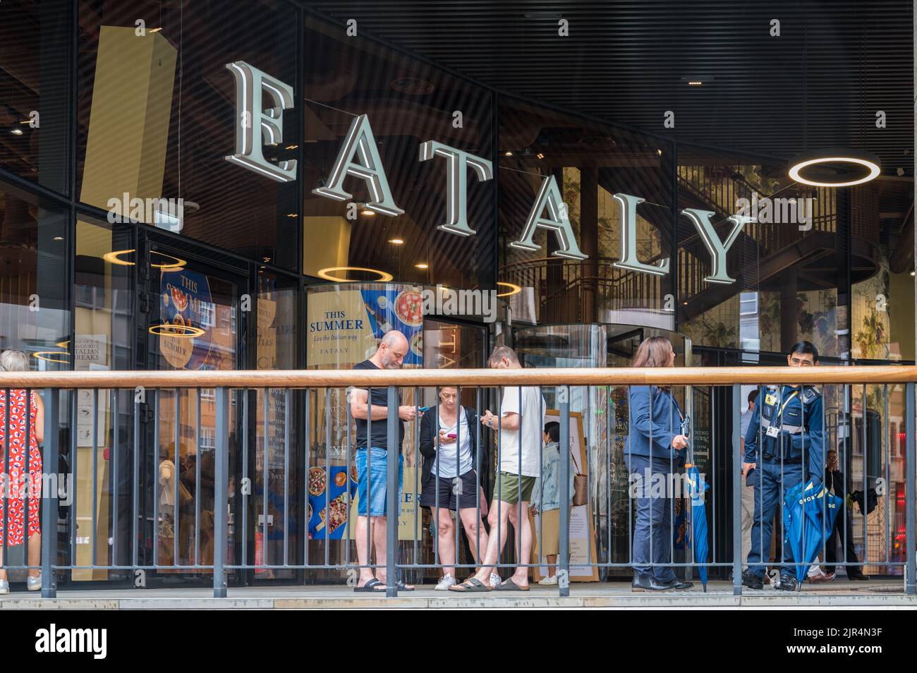 People grouped at the entrance to Eataly Italian restaurant, bar and ...