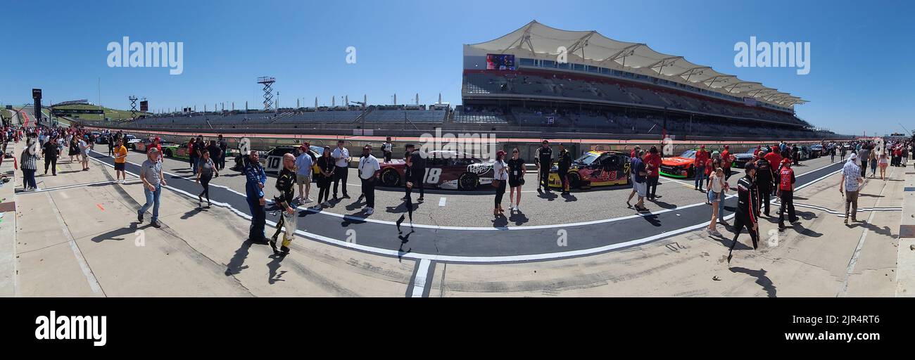 A panorama of people on a NASCAR race track before the race begins ...
