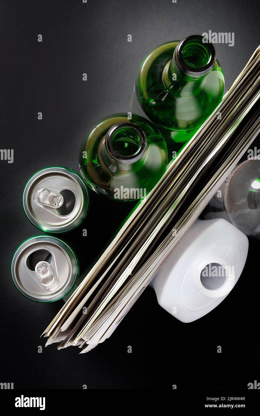 A collection of recyclable garbage items on black background from above ...