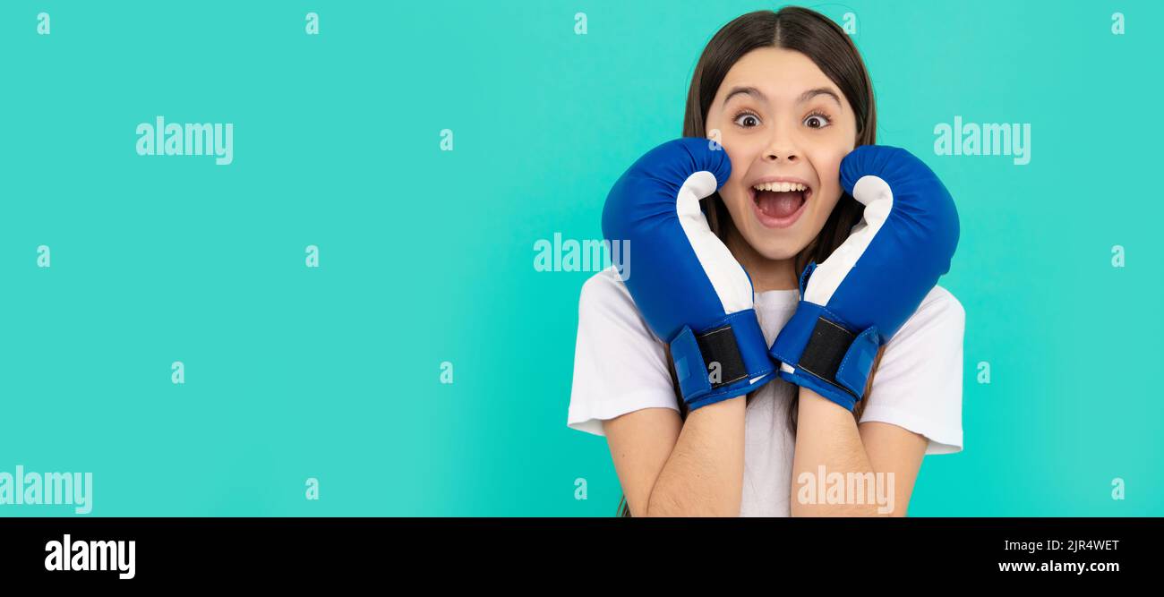 surprised teen girl boxer in boxing gloves during sport training, copy ...