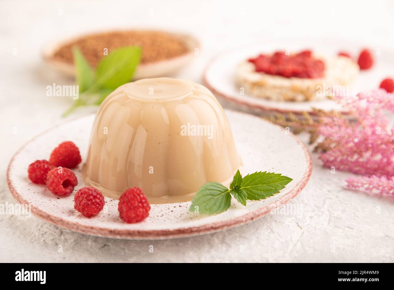 Buckwheat milk jelly on gray concrete background. side view, selective ...