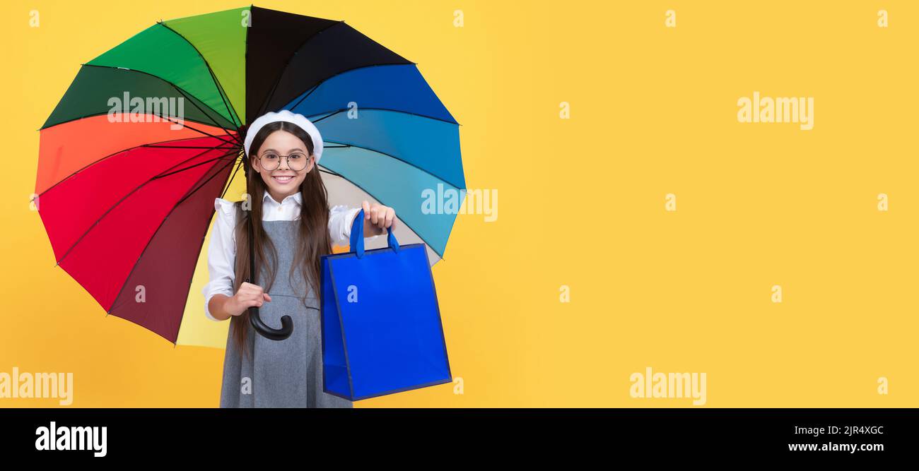 happy teen girl under colorful umbrella in autumn season hold shopping ...