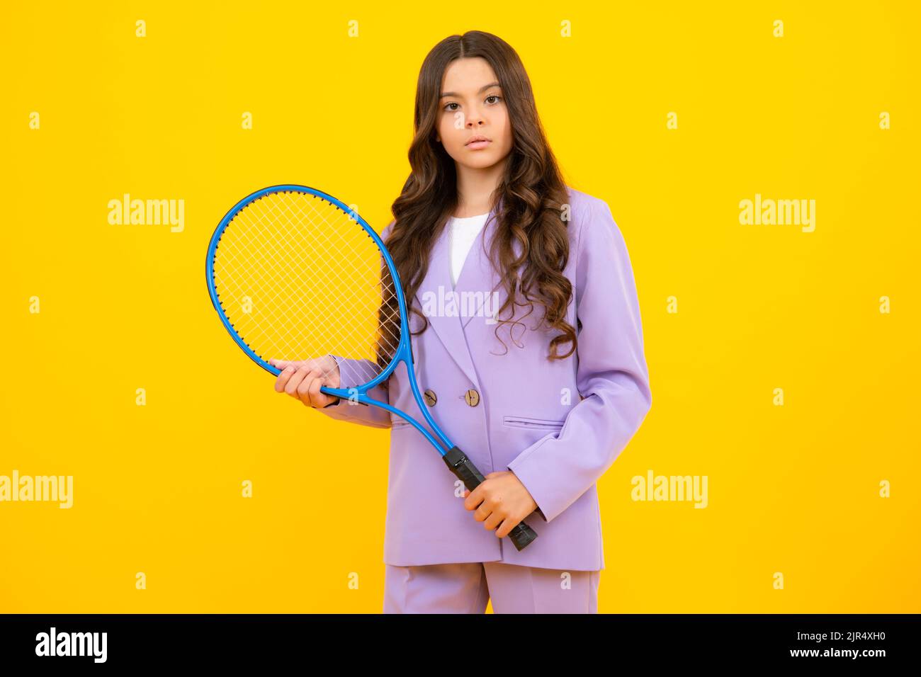 Teenage tennis player girl hold tennis racket over isolated yellow ...