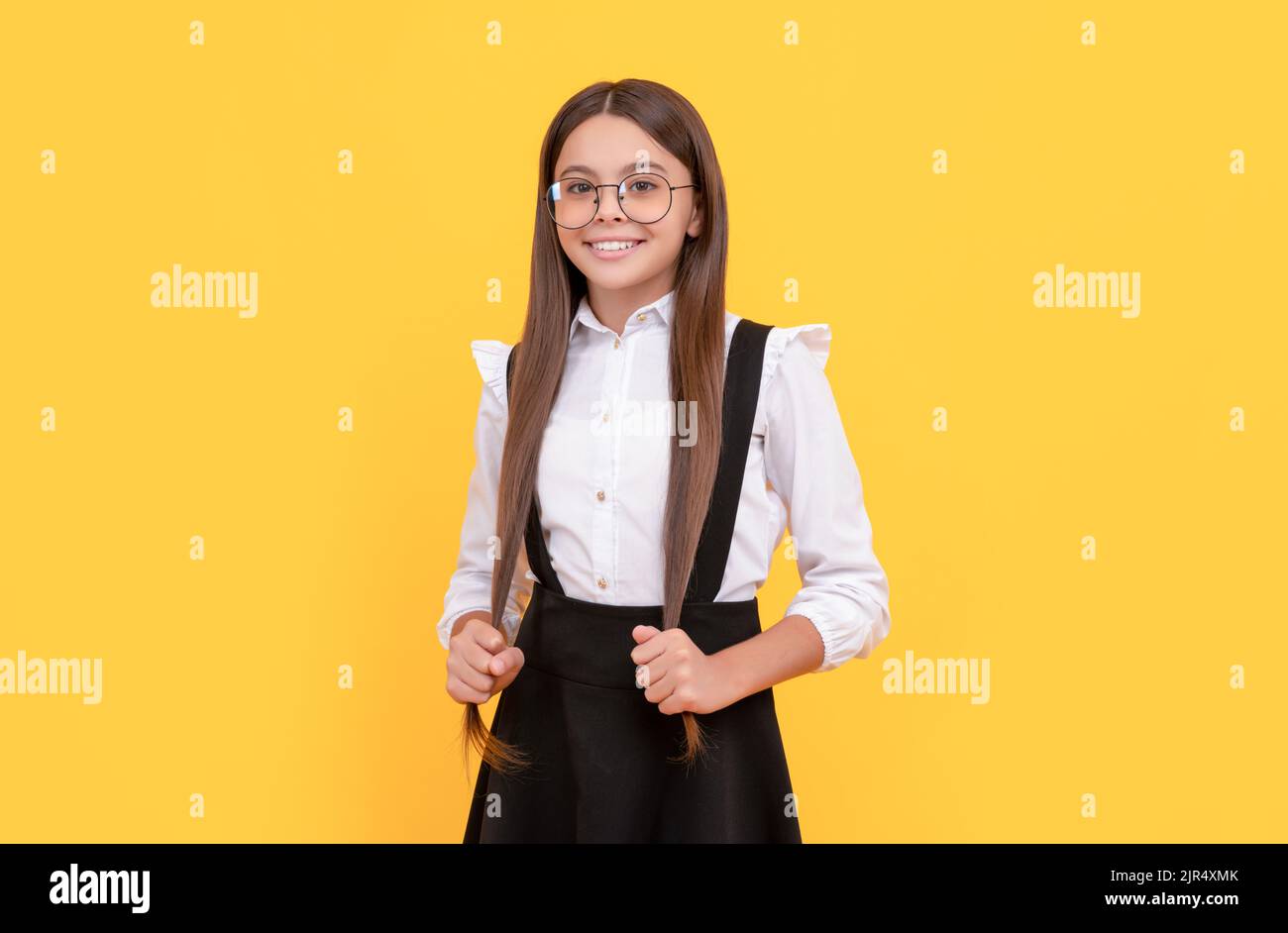 happy teen girl in school uniform and glasses for vision protection ...