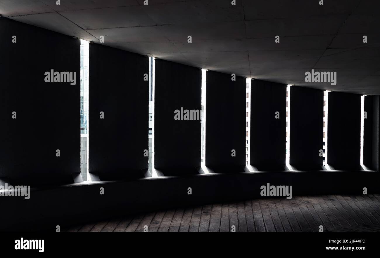 Light channels from cement wall of Curving shaped ramp on high building ...