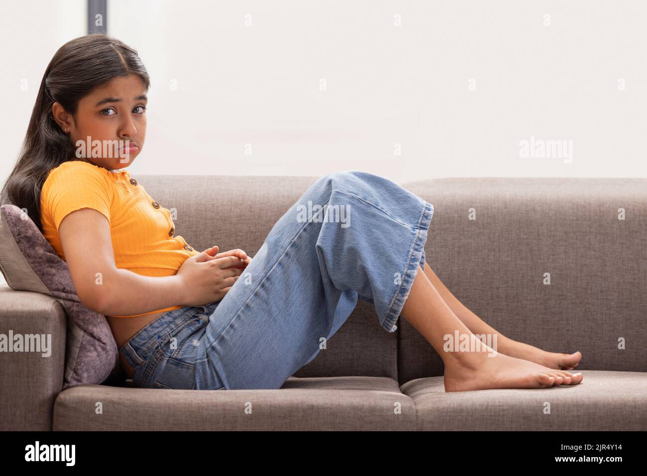 Portrait of a girl with sad facial expression Stock Photo - Alamy