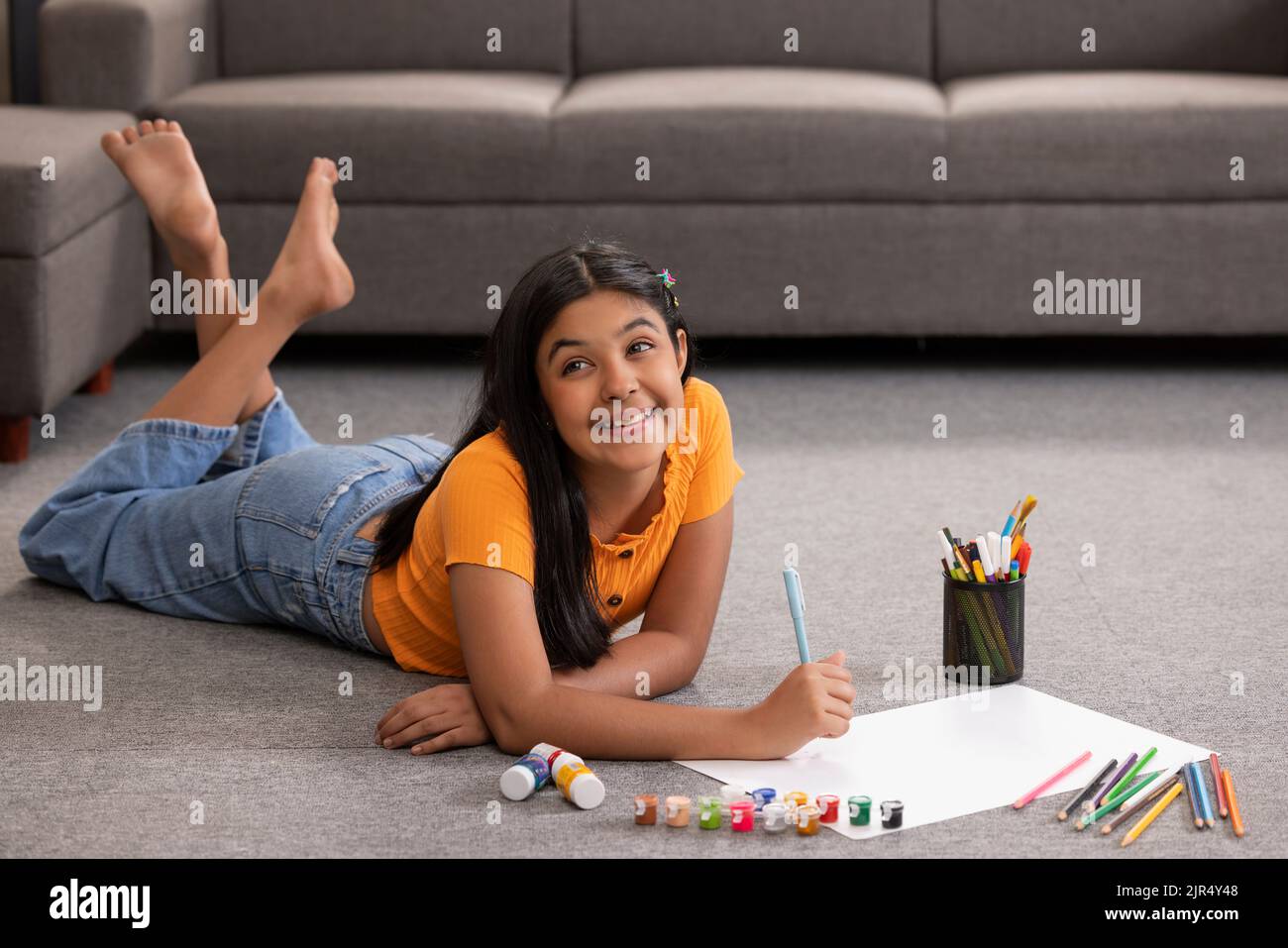 Girl lying on floor drawing hi-res stock photography and images - Alamy