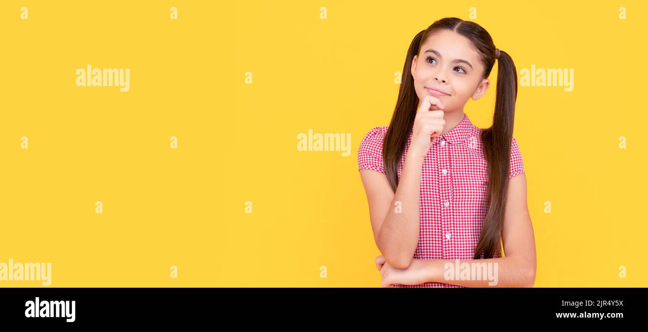 Start thinking big. Thoughtful girl yellow background. School age child ...
