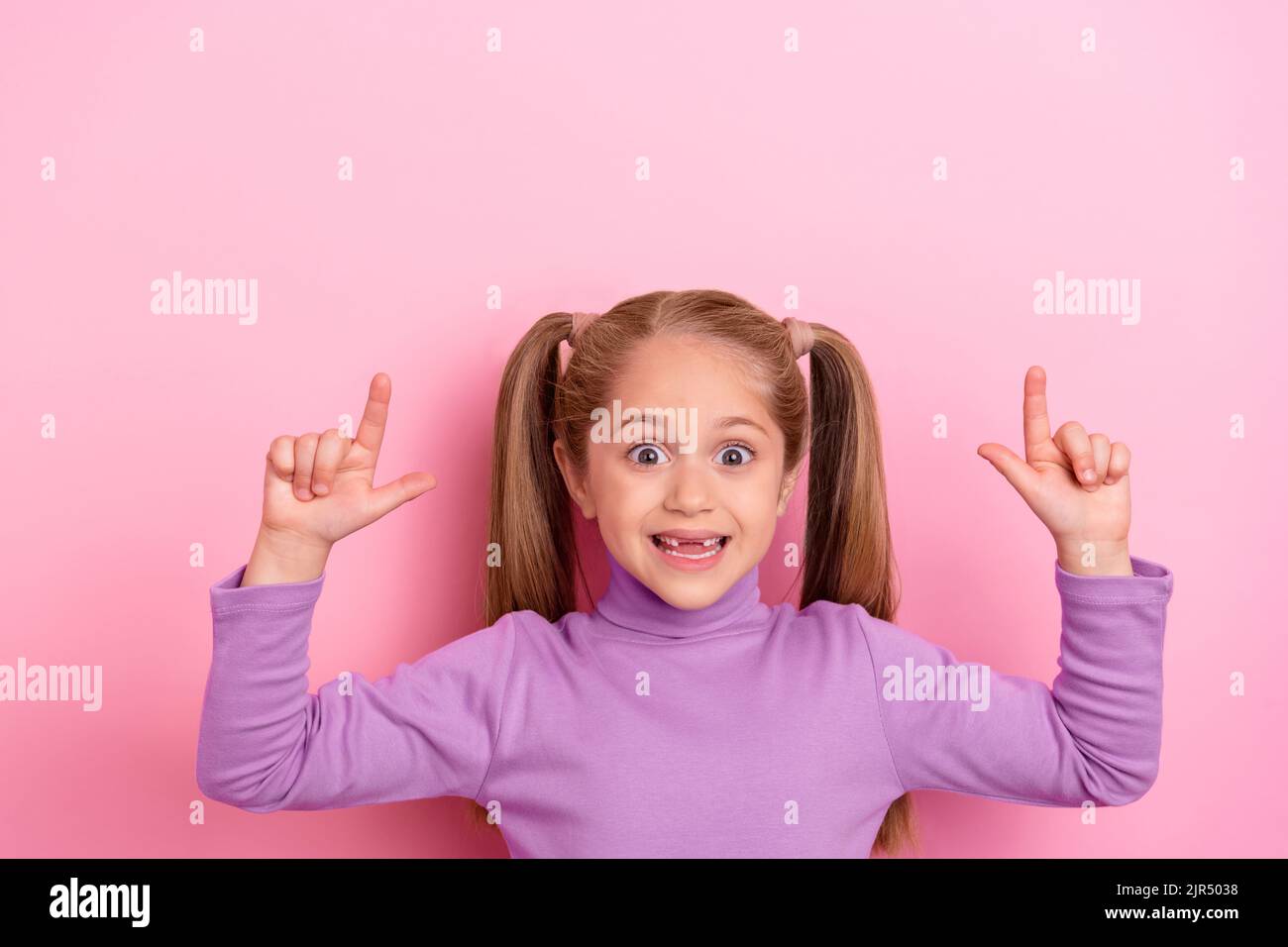 Photo of young charming cute little girl point fingers up promote ...