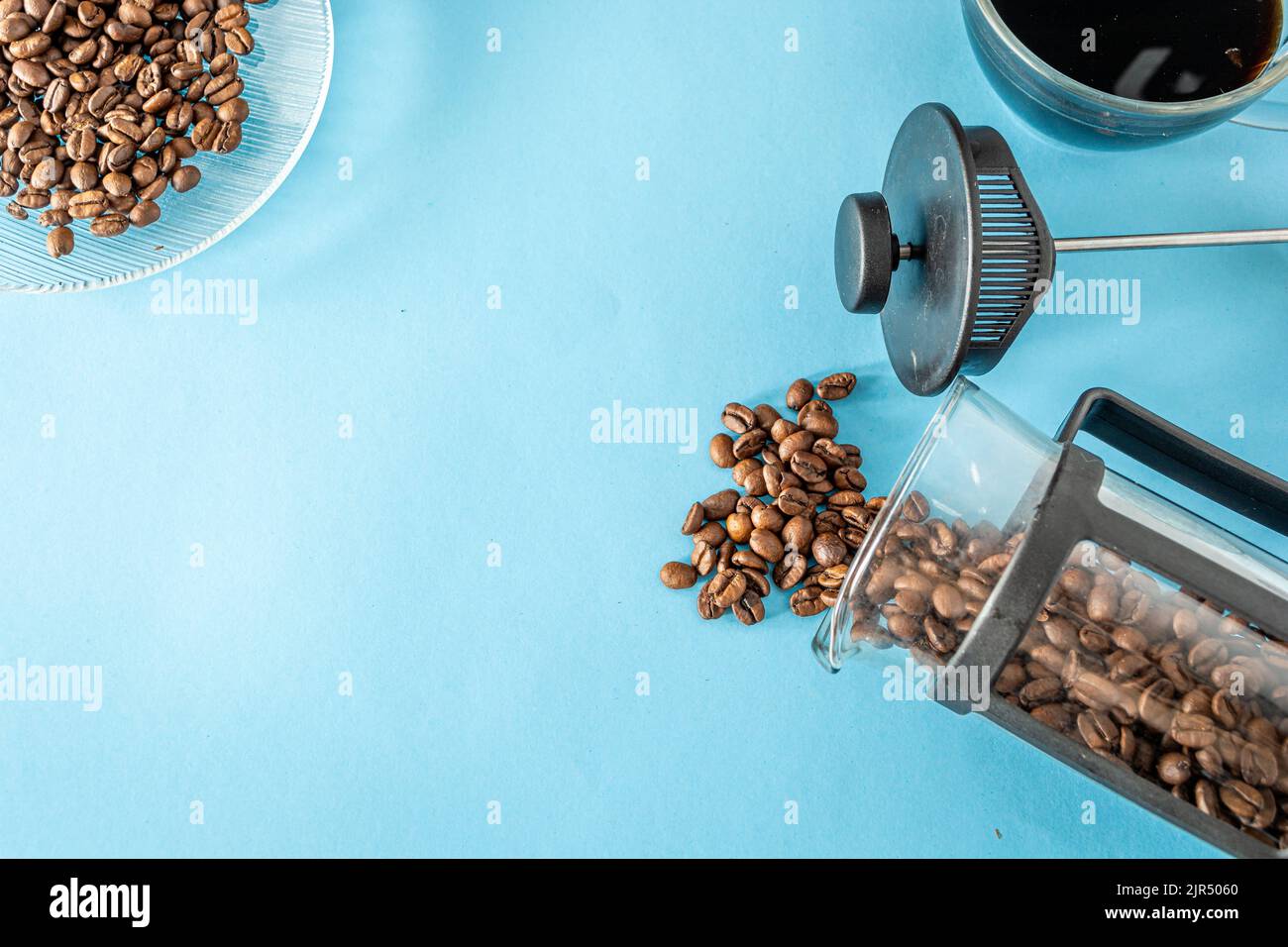 coffee beans and elements over blue background Stock Photo - Alamy