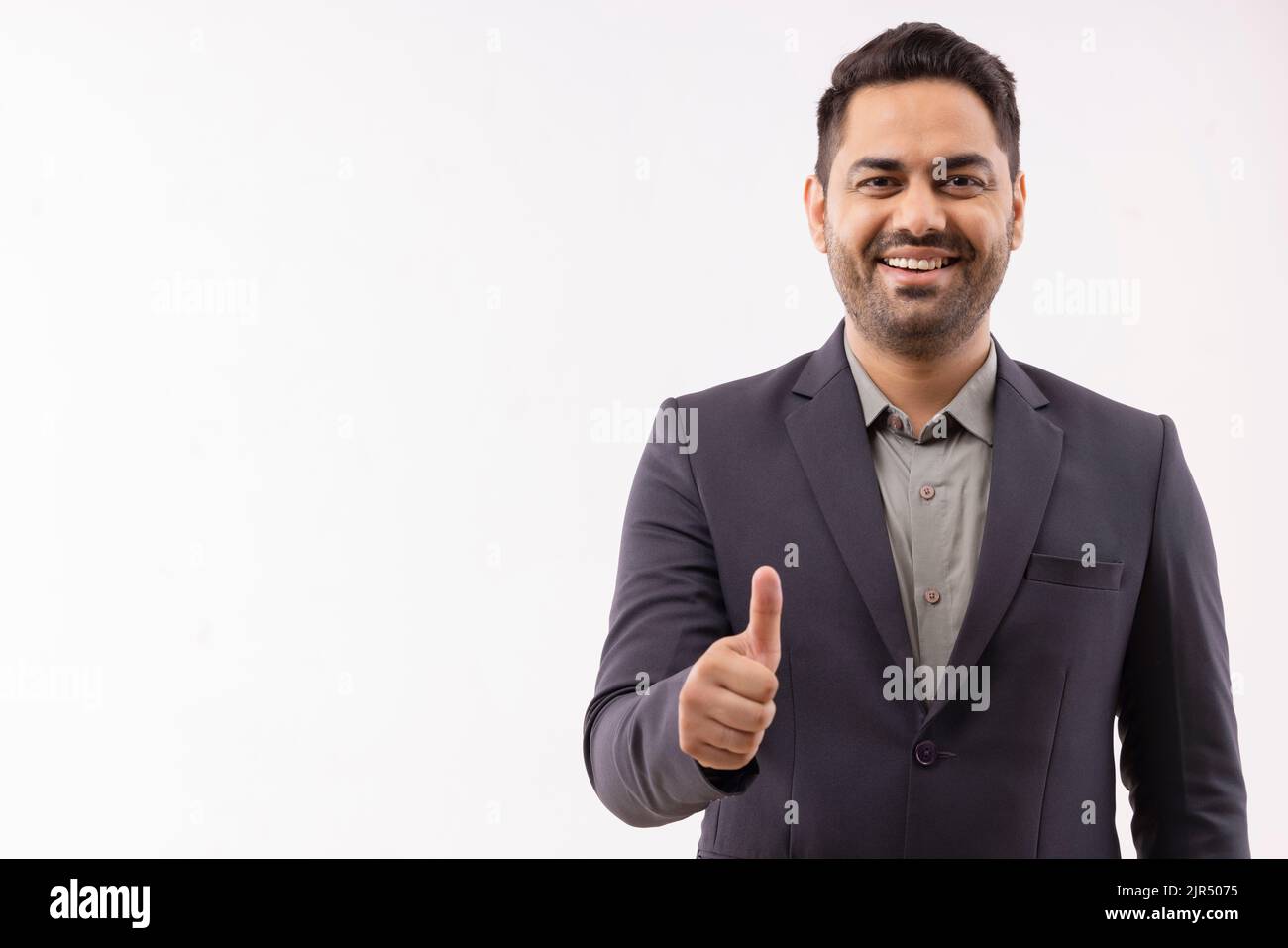 Young businessman in formal outfit showing thumbs up gesture hi-res ...