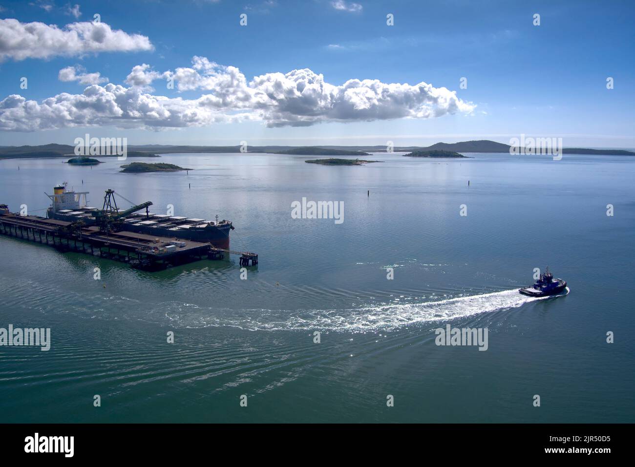 Aerial of tugboat passing the RG Tanna Coal Terminal at Port of ...