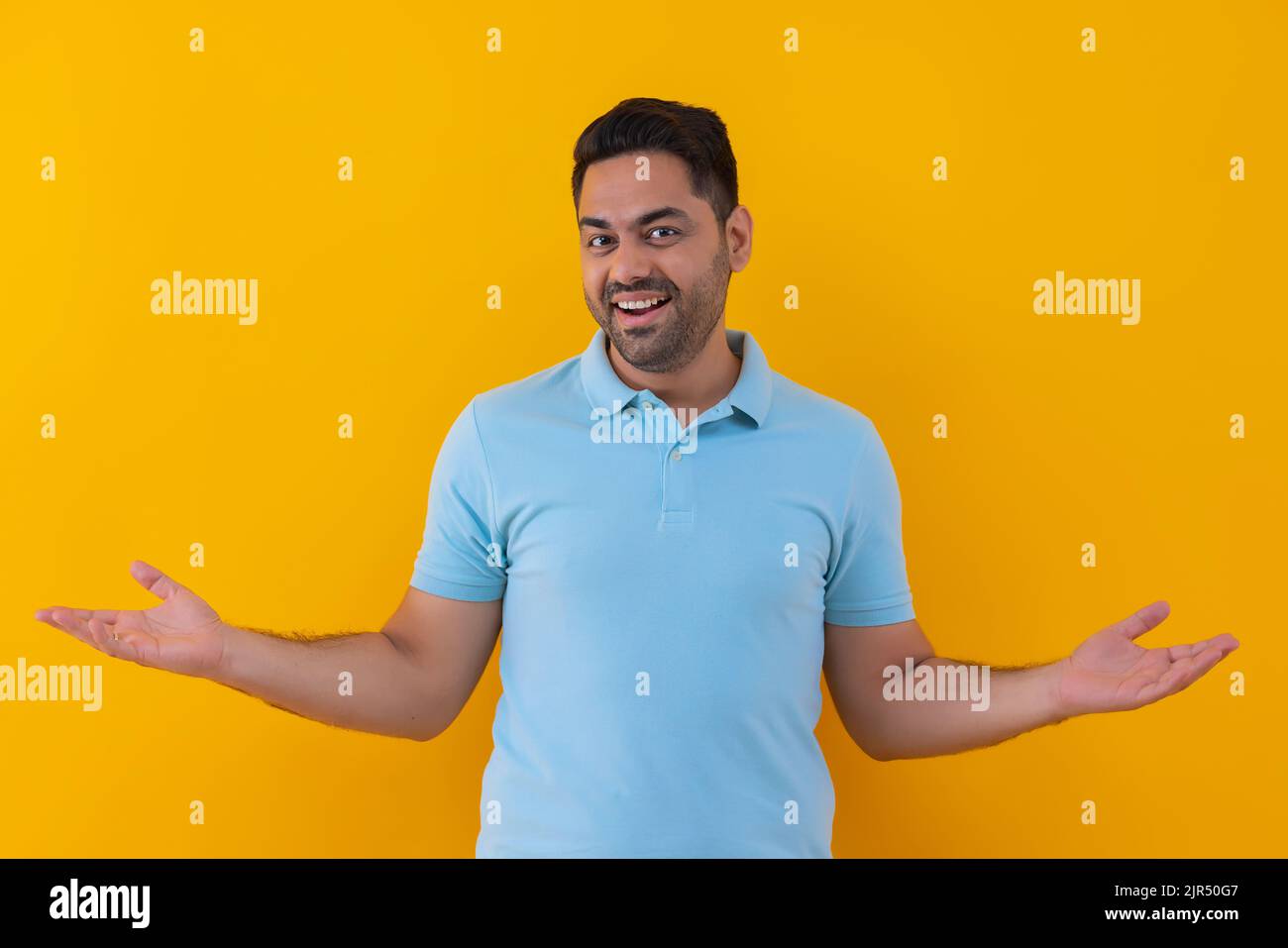 Portrait of a smiling young man standing with hands outstretched Stock ...