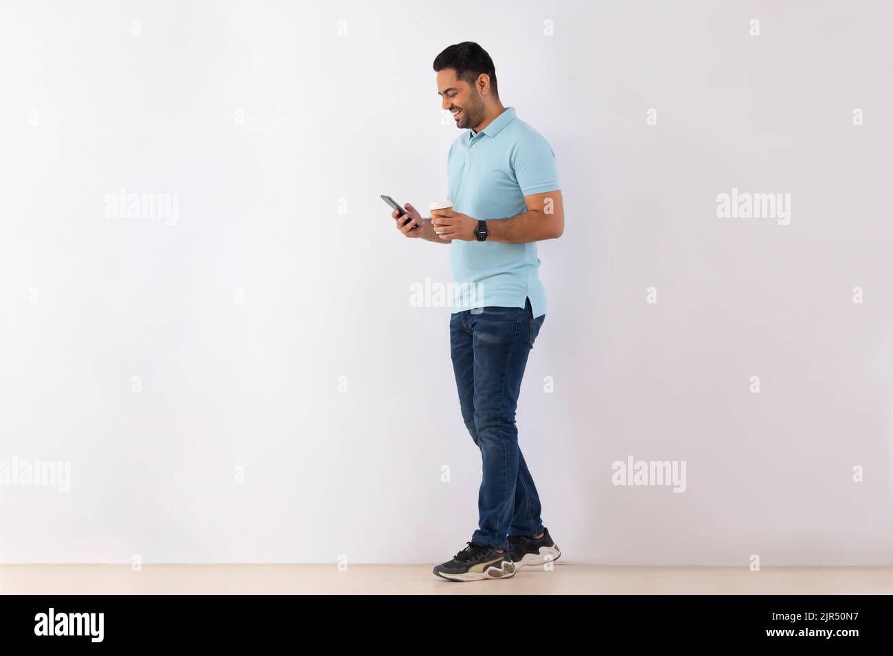 Portrait of a young man using Smartphone against white background Stock ...