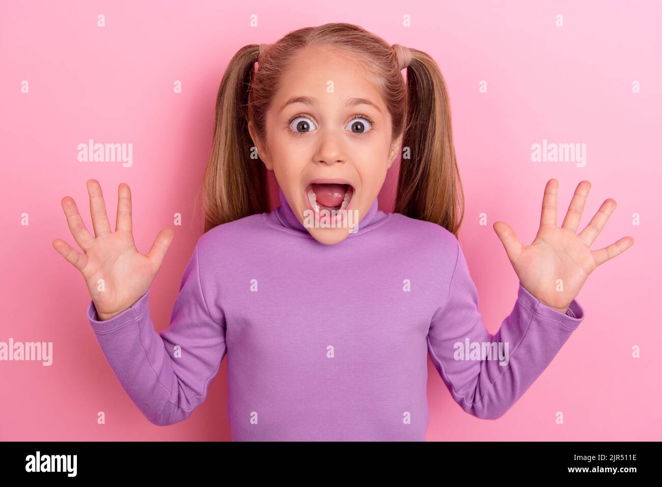 Photo of young pretty cute little girl playing hide and seek with ...