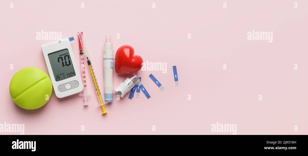 Composition with glucometer, syringer, lancet pen and heart on light ...