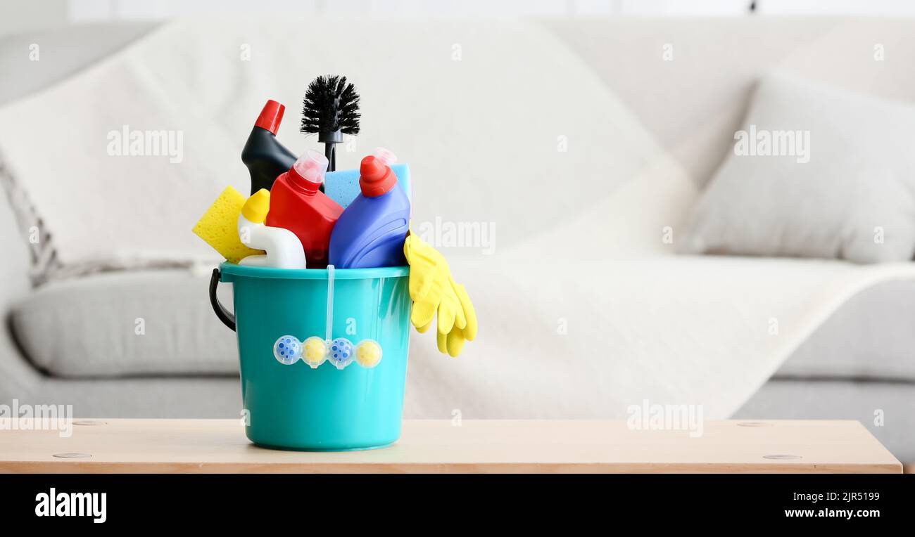 Set of cleaning supplies on table in room Stock Photo - Alamy