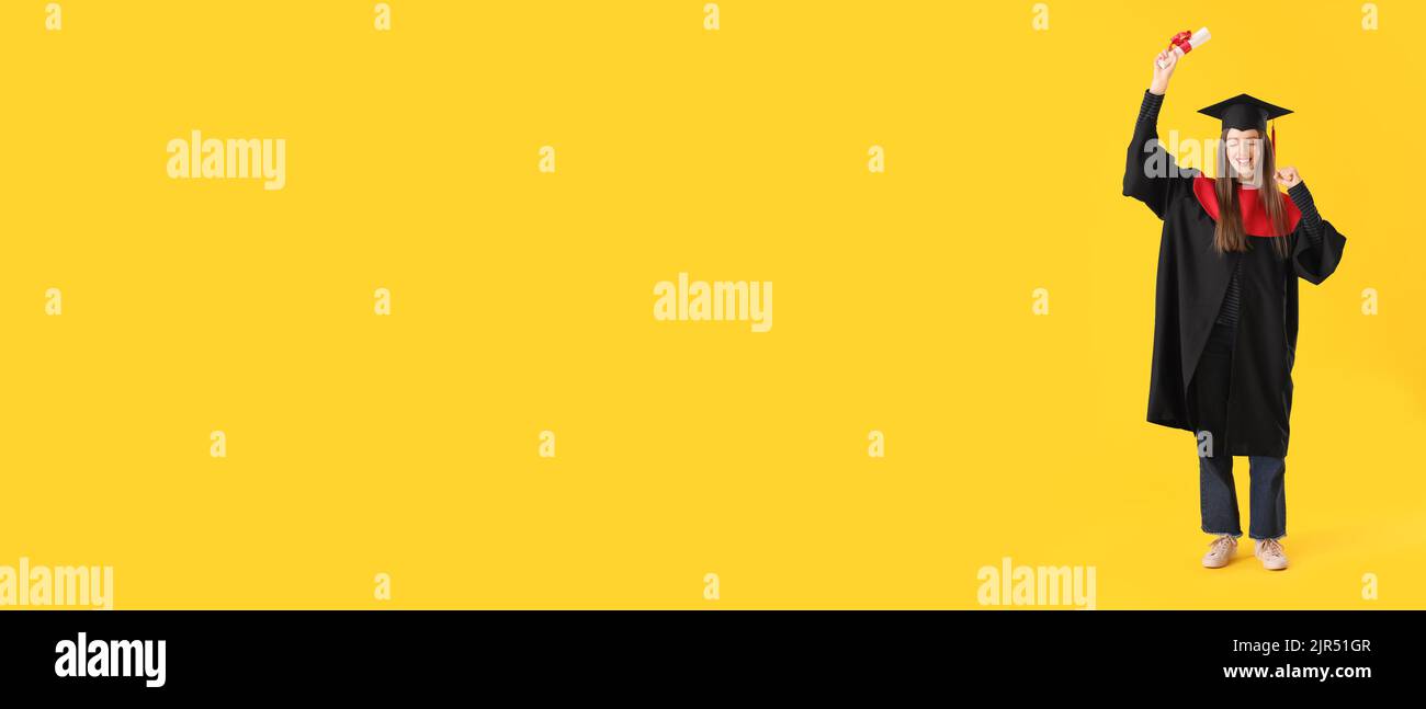 Happy female graduating student with diploma on yellow background with ...