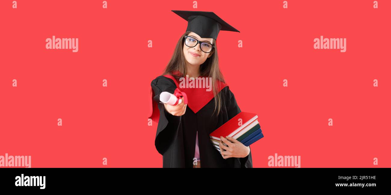 Female graduating student with diploma and books on red background ...