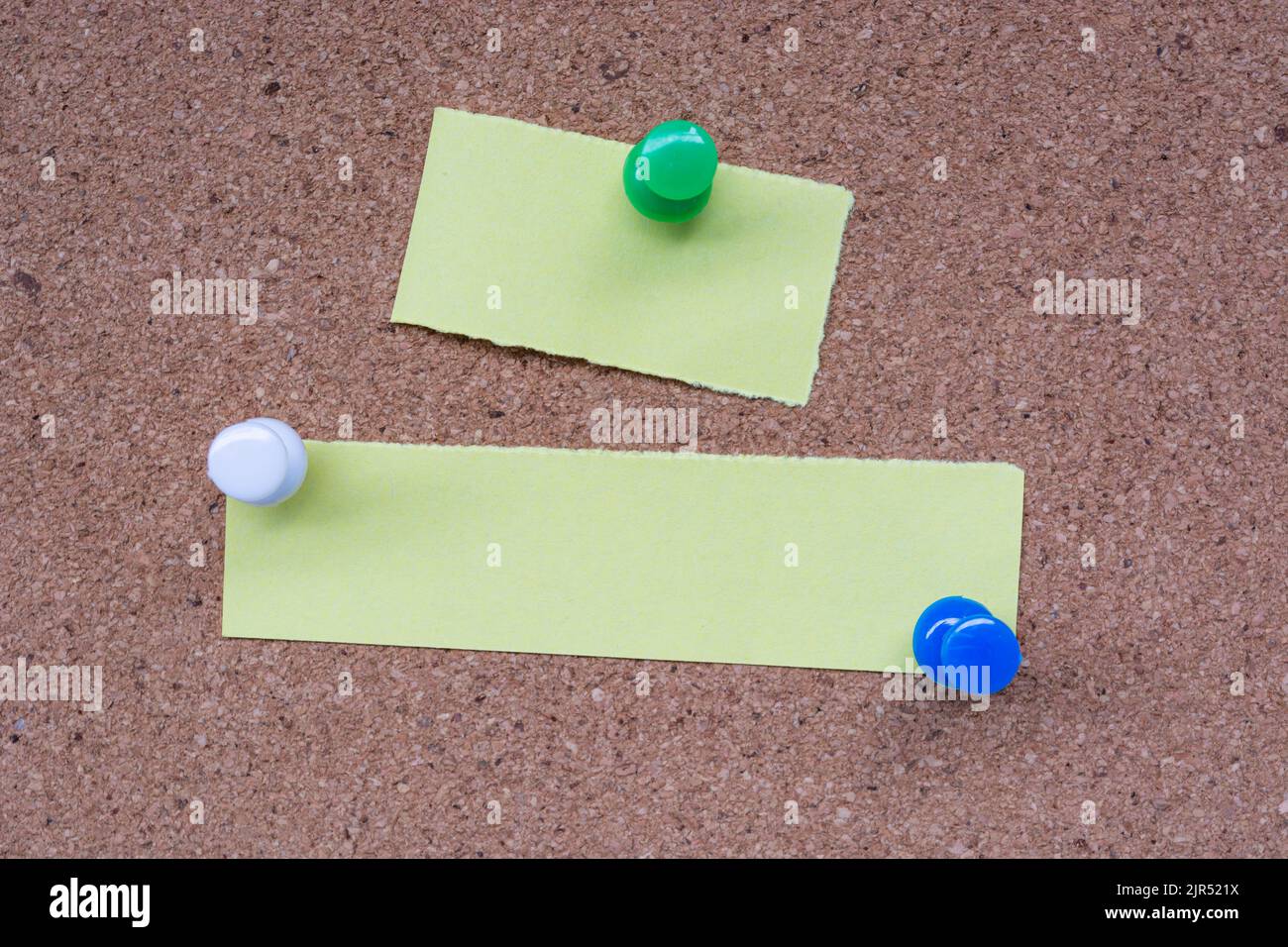 Yellow stick note and pinned to a cork notice board. Copy space ...