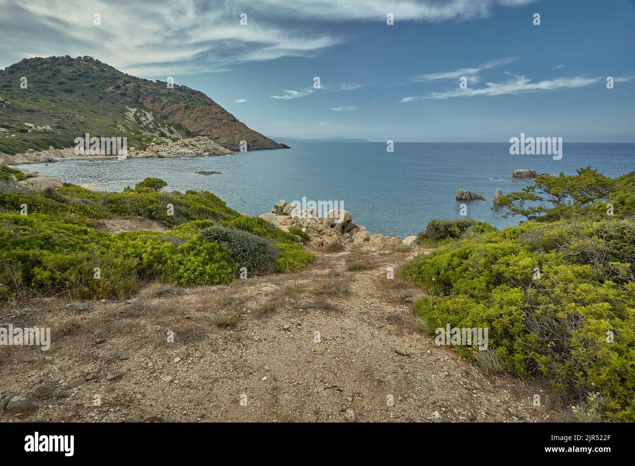 Small dirt road that opens into a beautiful bay on the Mediterranean ...