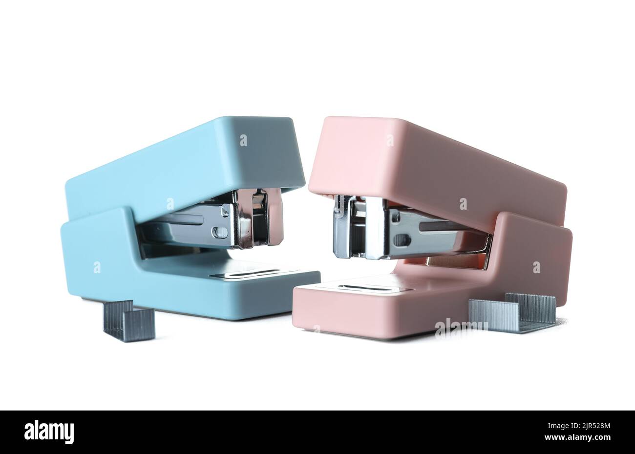Staplers and staples on white background Stock Photo - Alamy