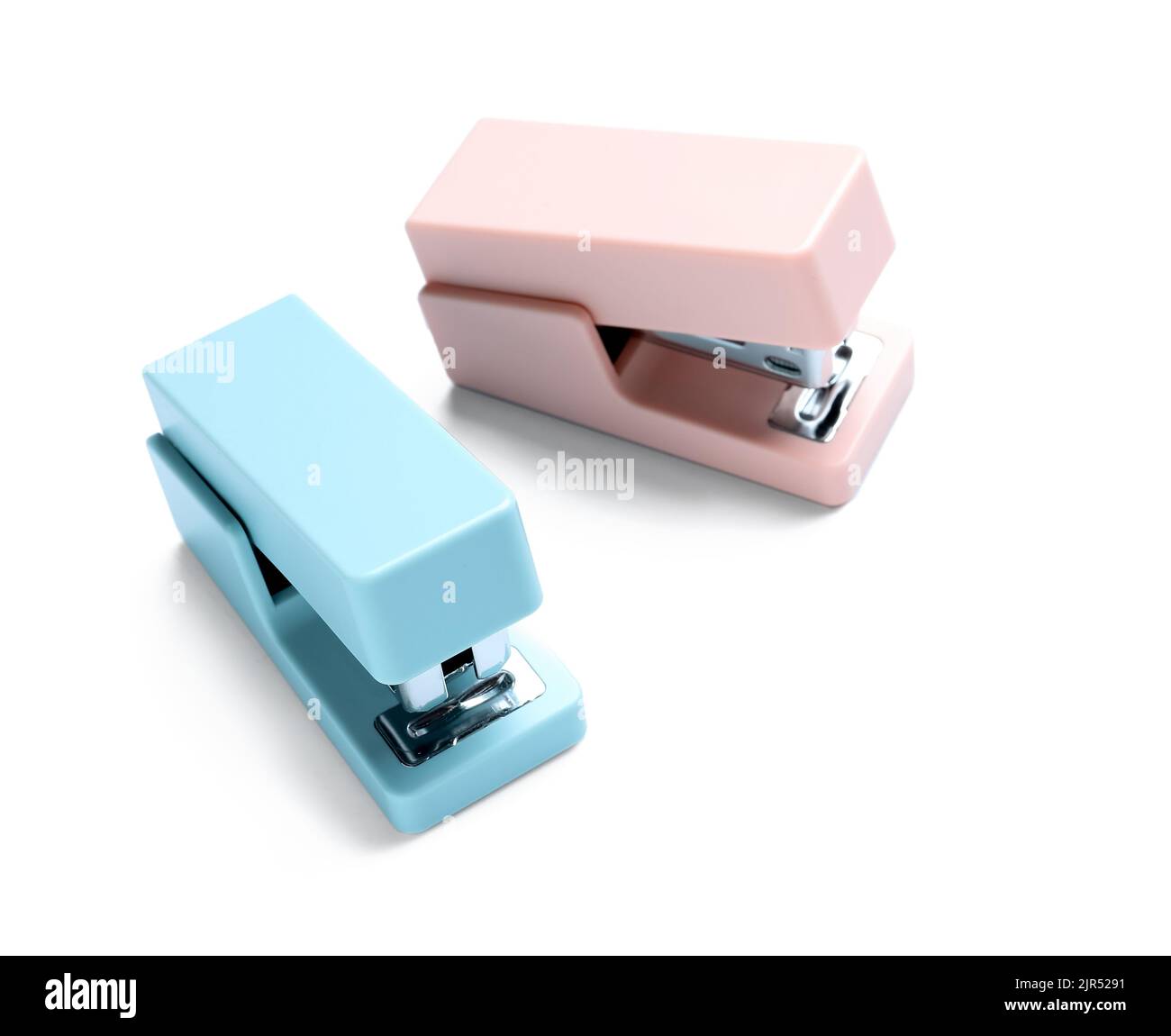 Two colorful staplers on white background Stock Photo - Alamy