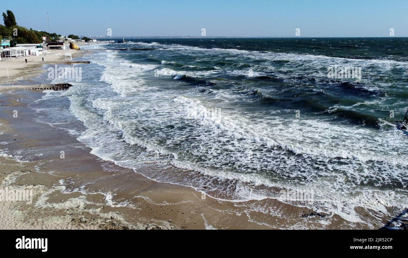 Aerial drone view flight over sea waves that roll onto sandy shore. Top ...