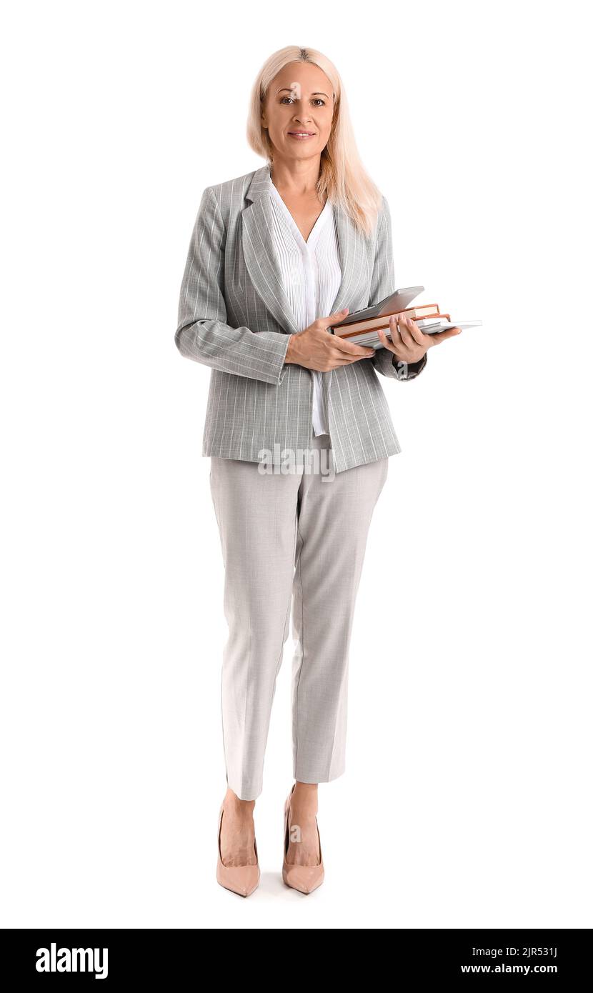 Mature Math teacher with calculator and books on white background Stock ...