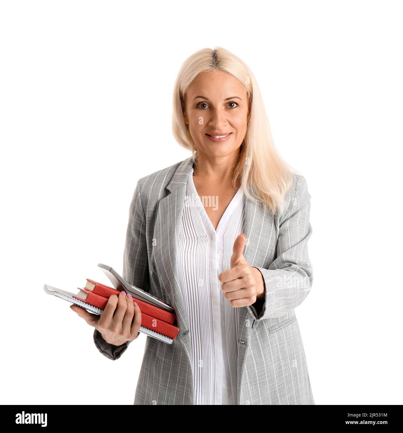 Mature Math teacher with calculator and books showing thumb-up on white ...