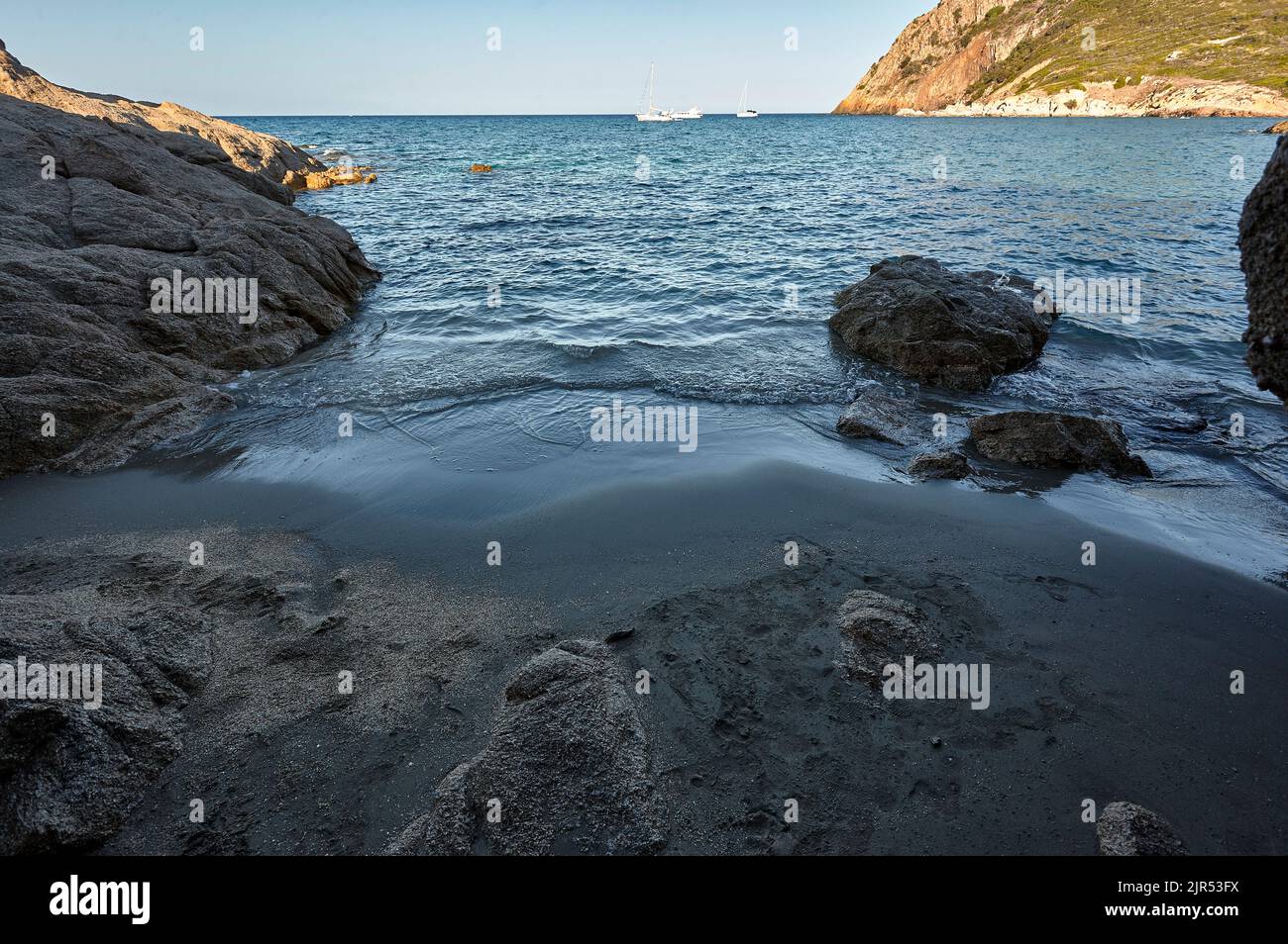 Hidden beach among the rocks at the exit of a natural cave in the south ...