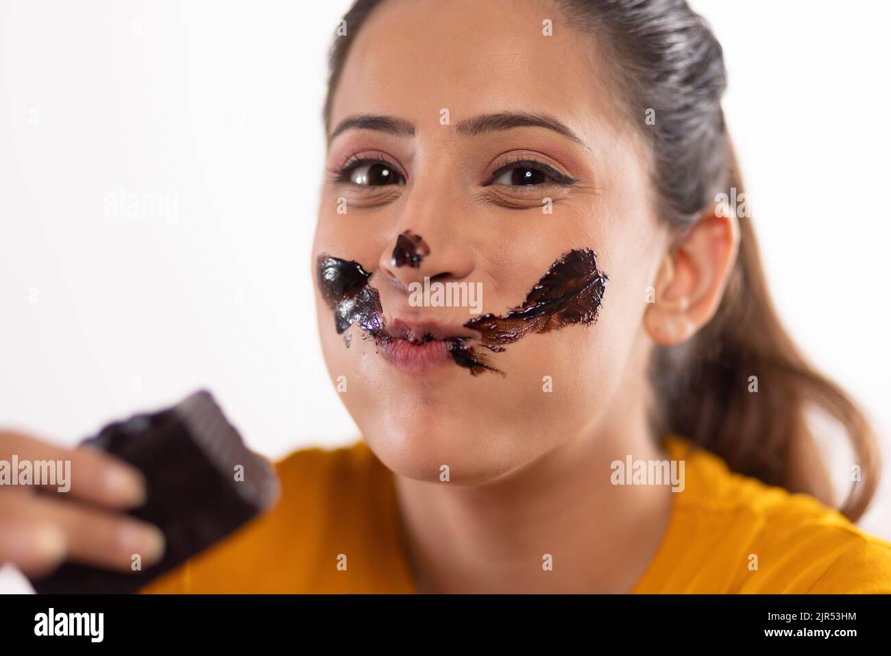 Indian woman eating chocolate hi-res stock photography and images - Alamy