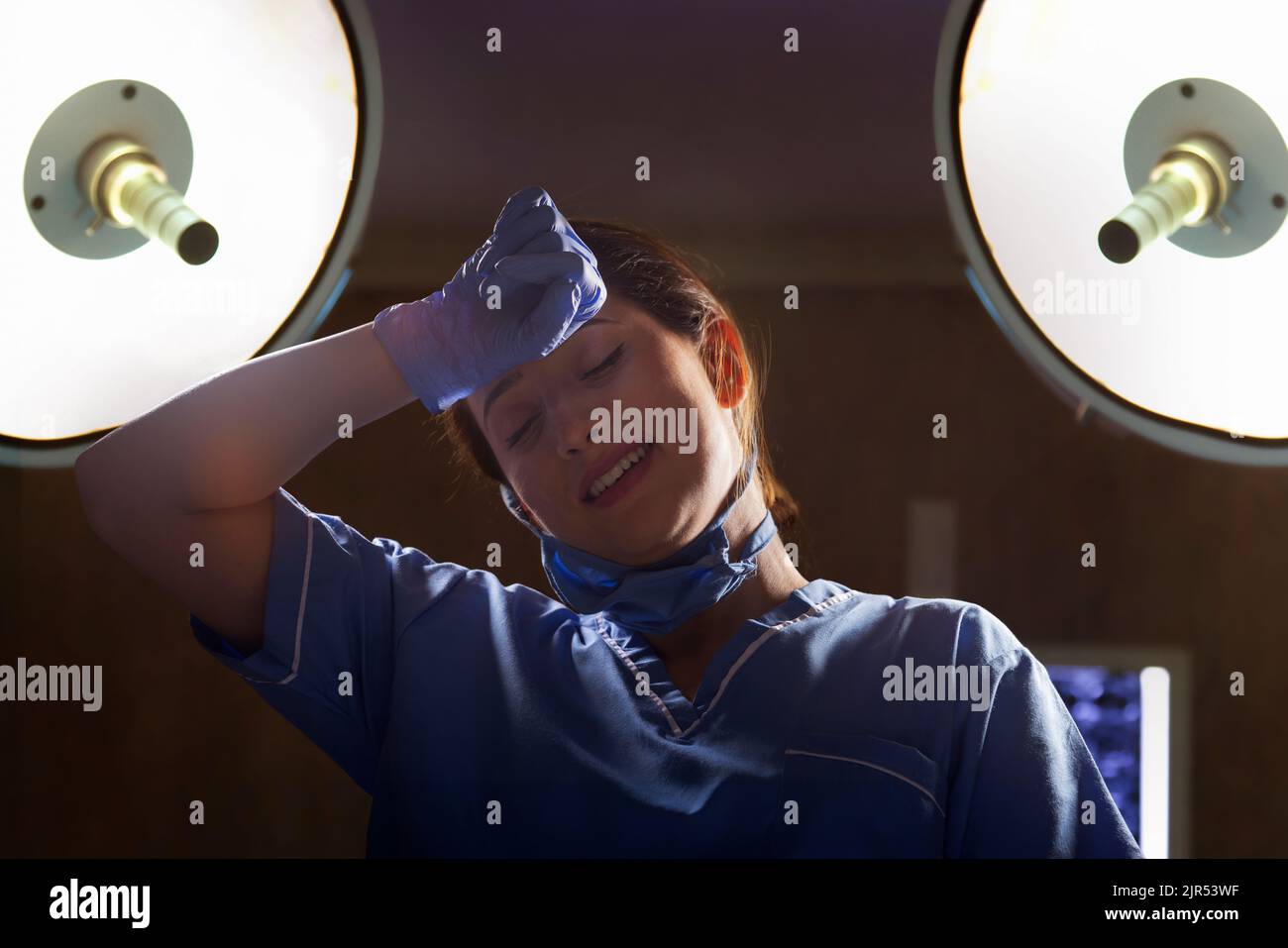 Portrait of tired female nurse after surgery in operating theatre Stock ...