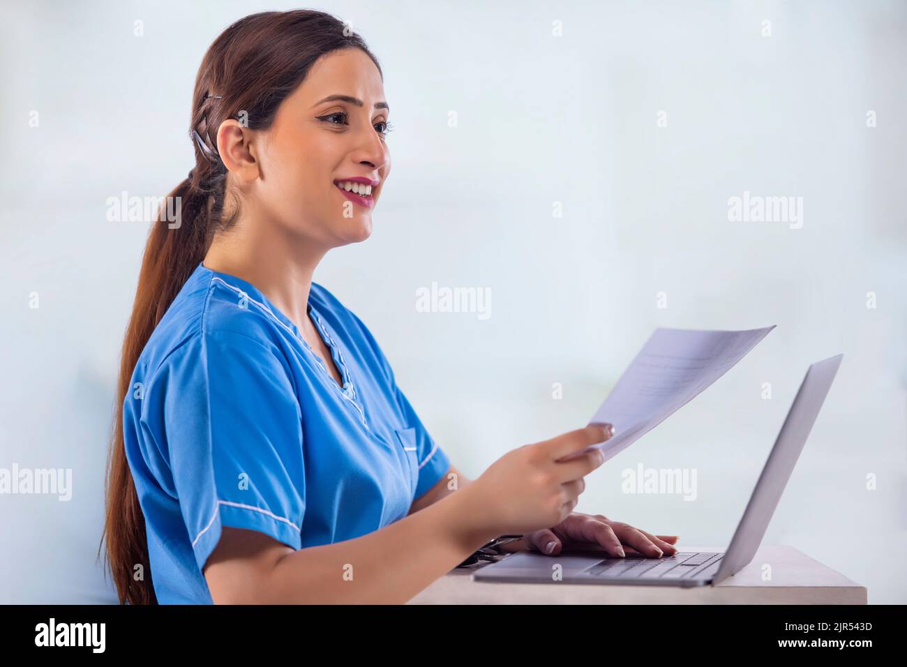 Portrait of female nurse with some medical report Stock Photo - Alamy