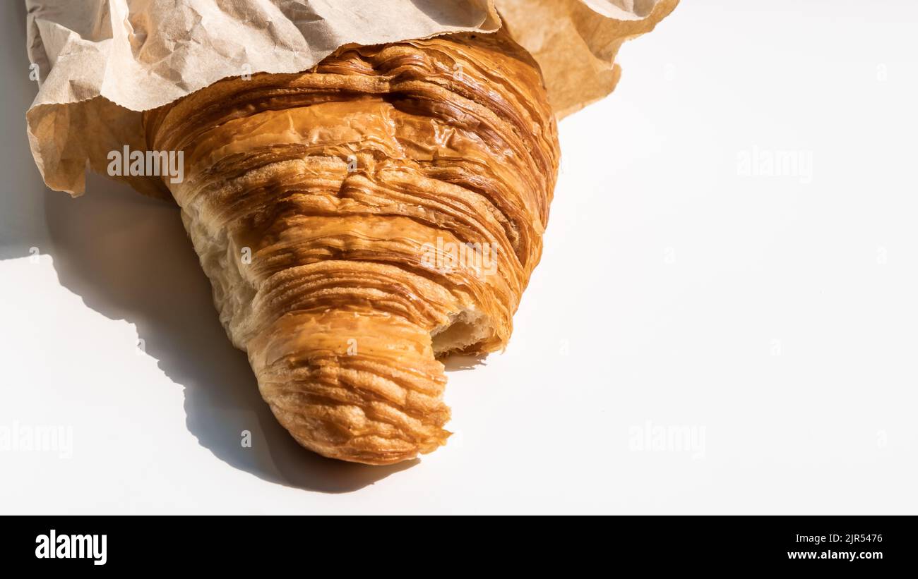 Tasty croissant in the brown craft packet, junk food concept Stock ...