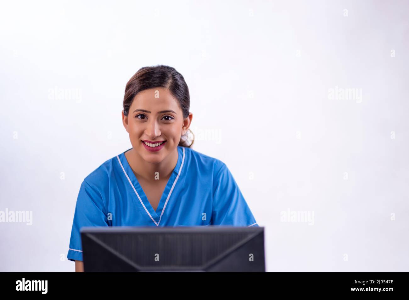 Portrait of a cheerful female nurse using computer Stock Photo - Alamy