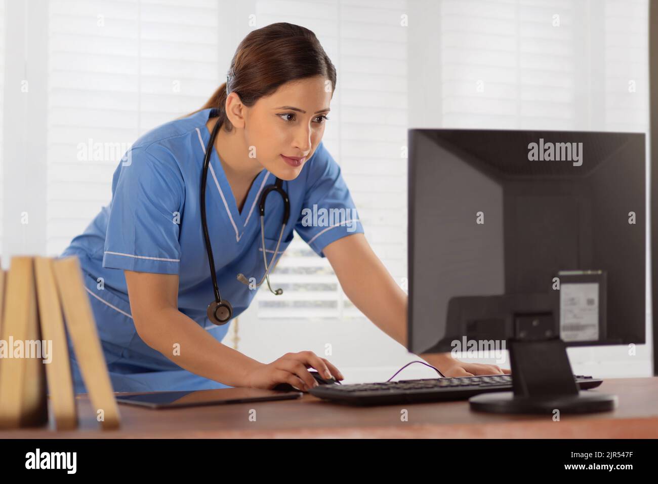 Female nurse using computer in the hospital Stock Photo - Alamy
