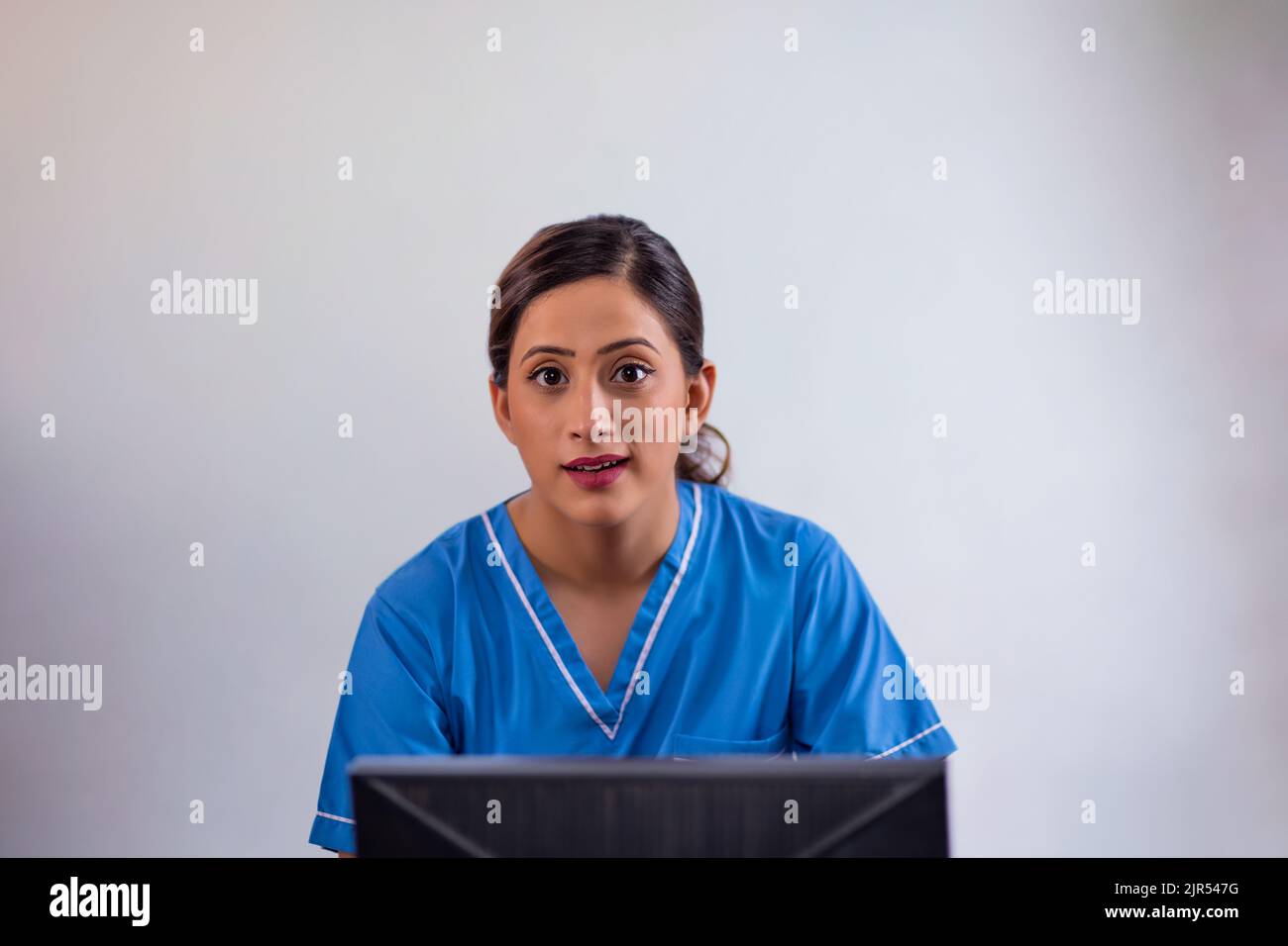 Portrait of a cheerful female nurse using computer Stock Photo - Alamy