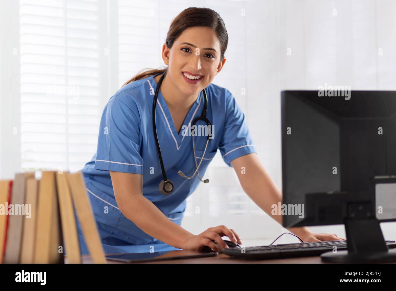 Female nurse using computer in the hospital Stock Photo - Alamy