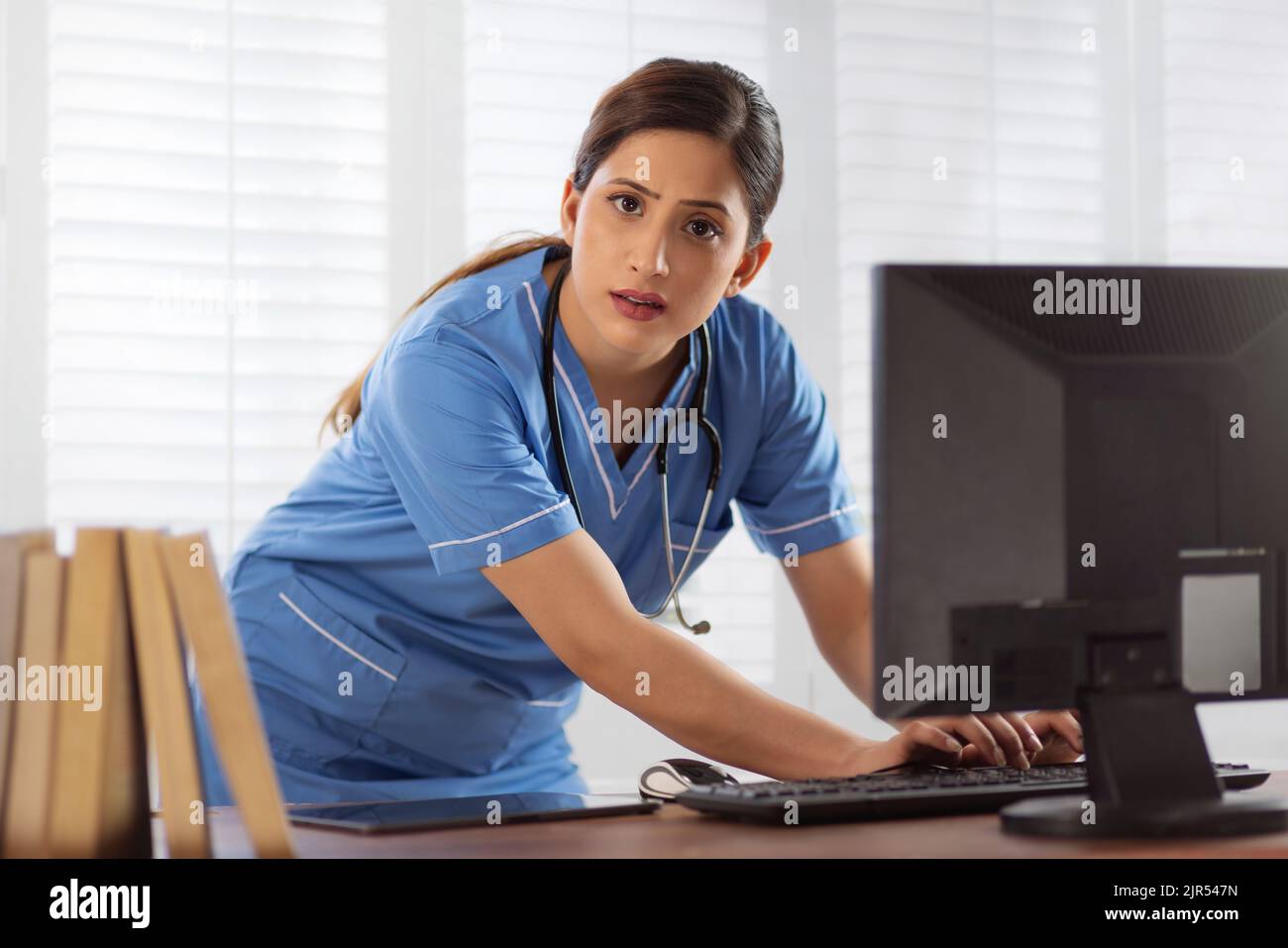 Female nurse using computer in the hospital Stock Photo - Alamy