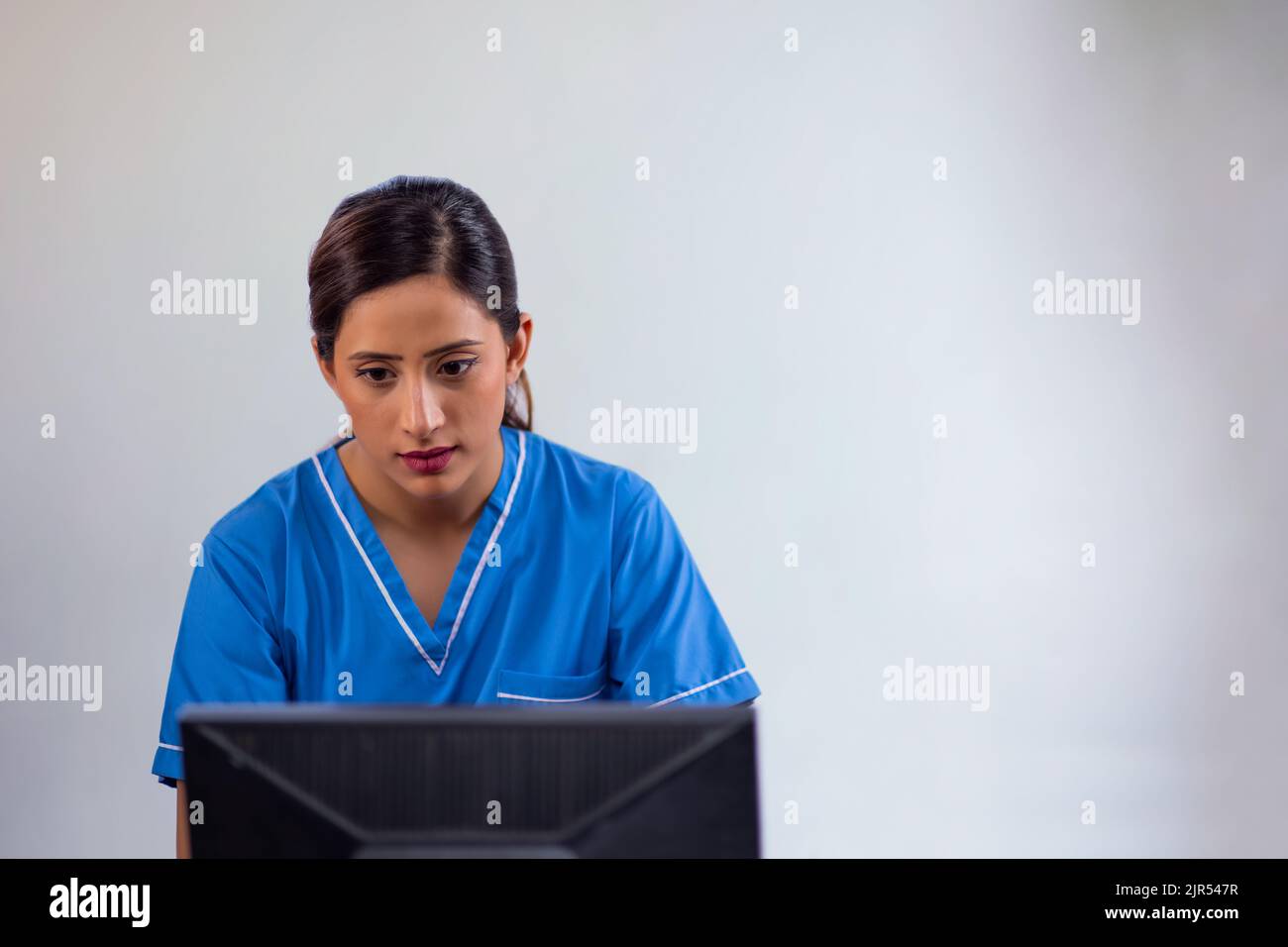 Portrait of a cheerful female nurse using computer Stock Photo - Alamy