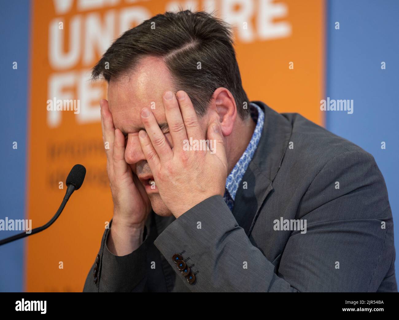 Berlin, Germany. 22nd Aug, 2022. The writer Uwe Tellkamp holds his ...