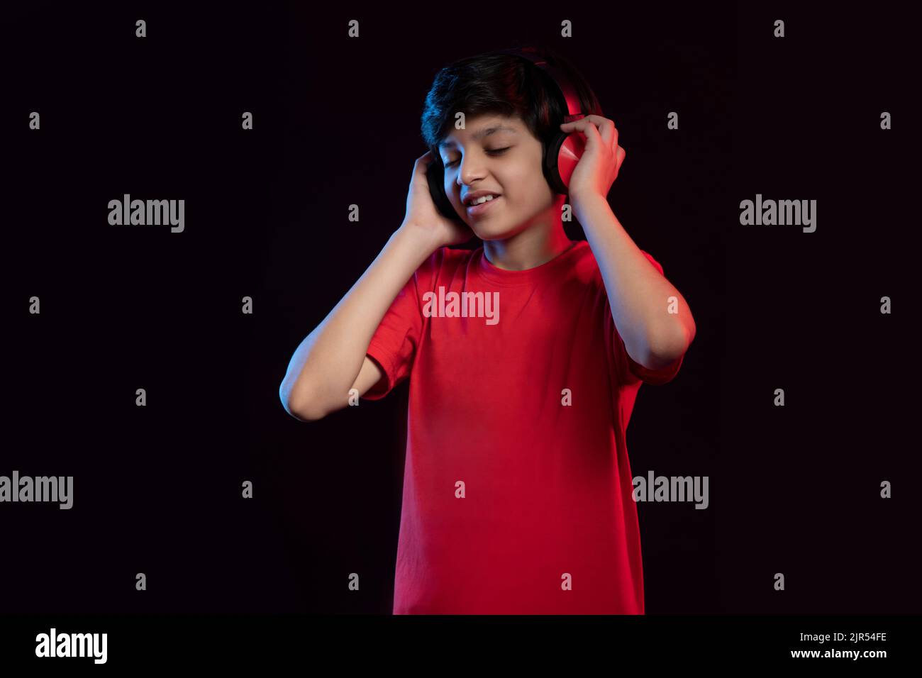Portrait of boy listening music with headphone Stock Photo - Alamy