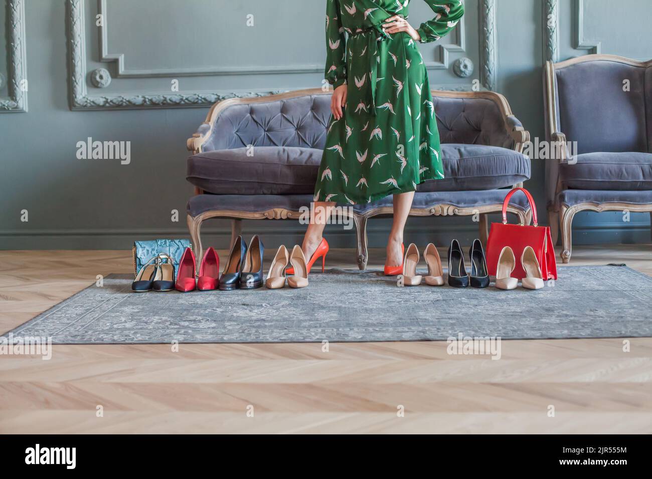Female model chooses shoes in luxurious room, legs closeup Stock Photo ...