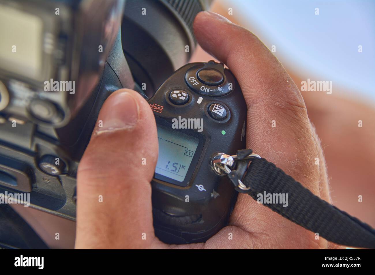 Hand holding the camera close with the finger ready to press the ...