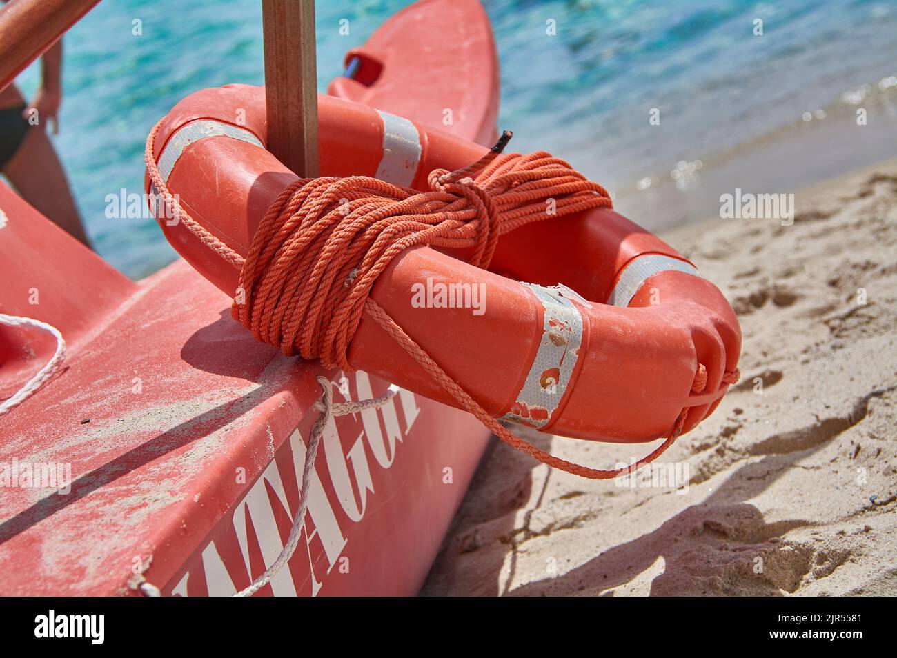 Still life including a plastic life jacket with a rope tied around it ...