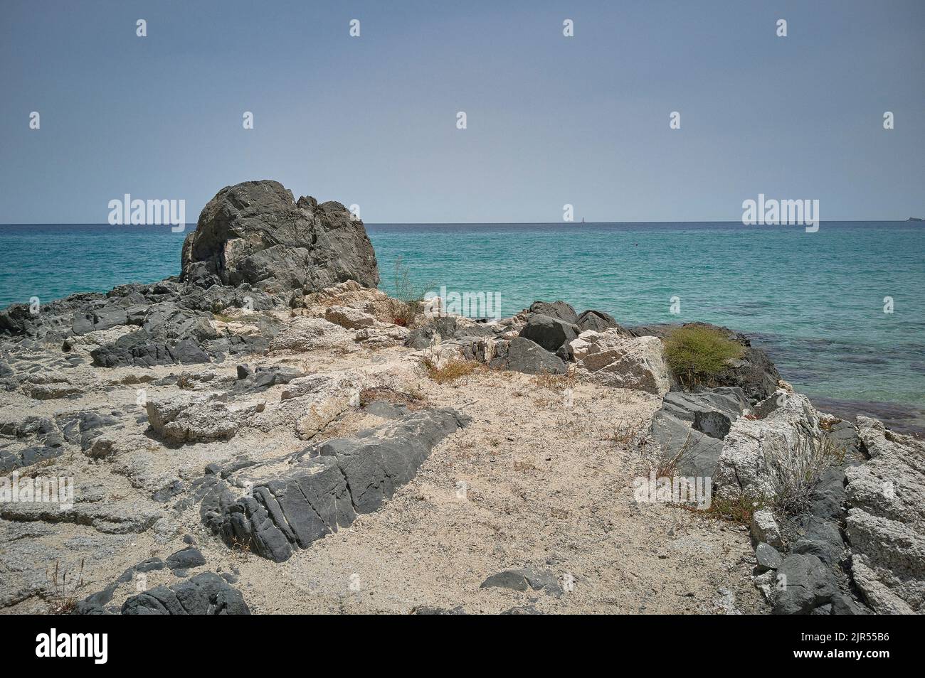 Rocky promontory overlooking the blue water of the sea in an ...