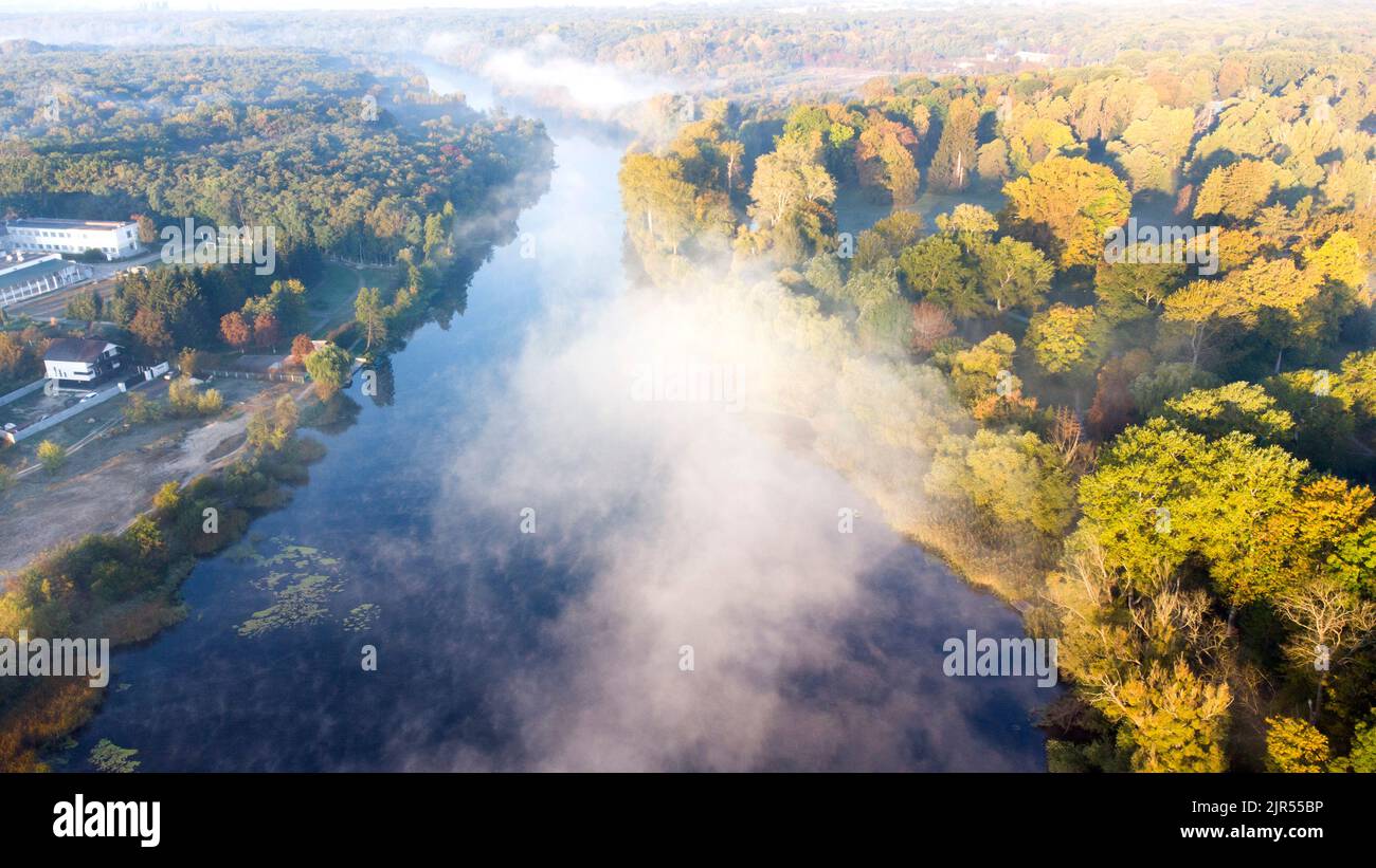 Aerial drone view flying over the river with calm reflective water ...