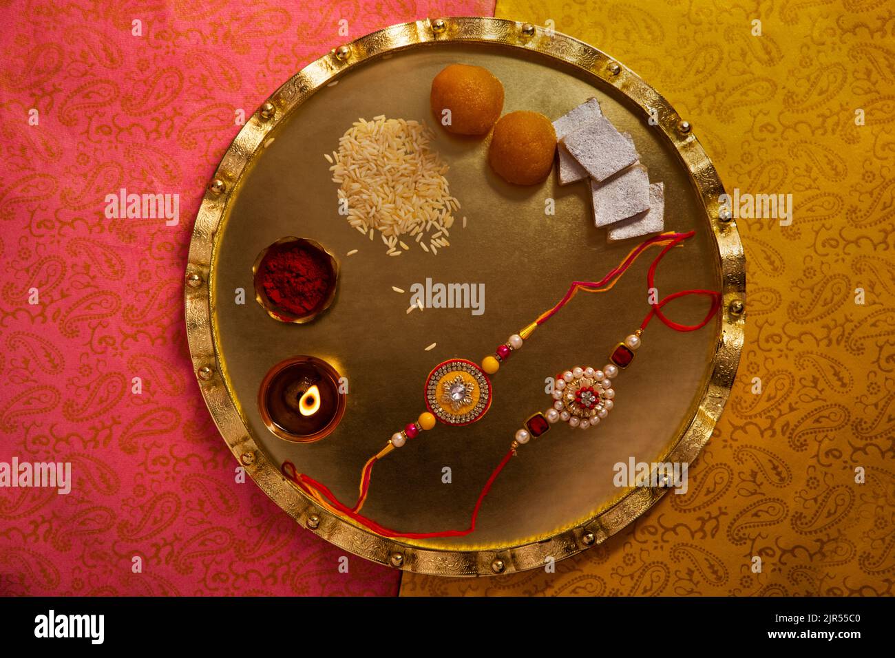 Decorative thali filled with rakhi and sweets on the occasion of ...