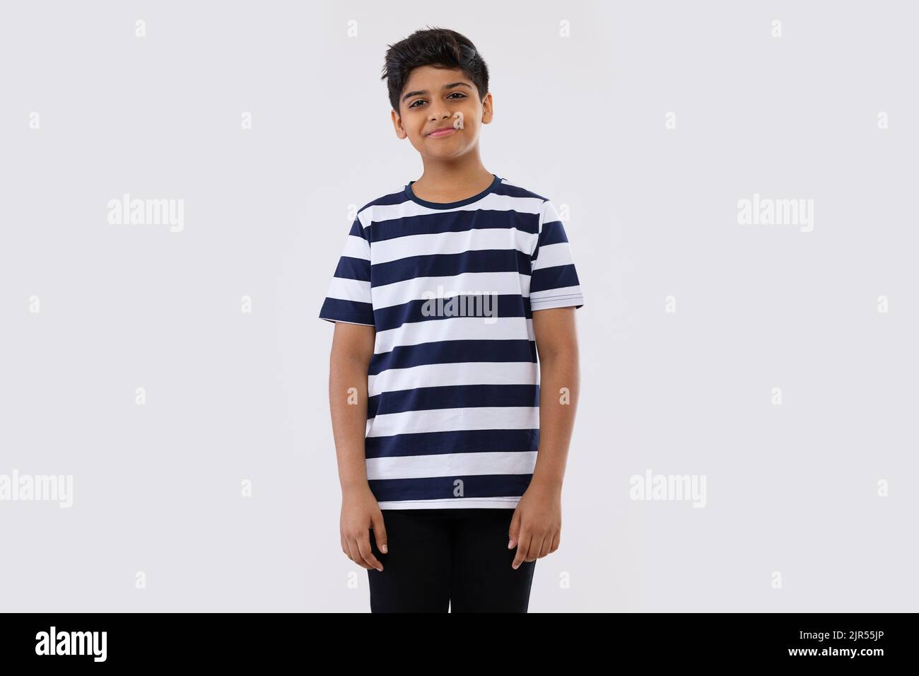 Portrait of a cheerful boy standing against white background Stock ...